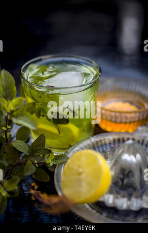 Close up of Herabal drink or Basil lemonade in a transparent glass with ...