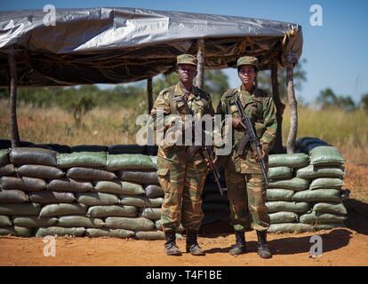 Six African soldiers pose, two kneeling at the front and four standing ...