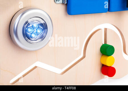 labyrinth with multi-colored puzzles on a wooden busy board ...