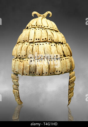Boar's tusk helmet with cheek guards and double bone hook on top. Tomb ...
