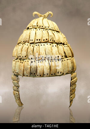 Boar's tusk helmet with cheek guards and double bone hook on top. Tomb ...