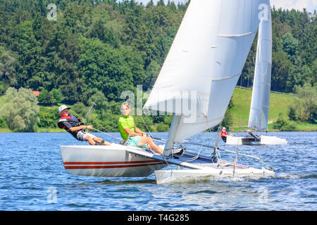 Catamaran sailing on inland lake in summertime Stock Photo - Alamy