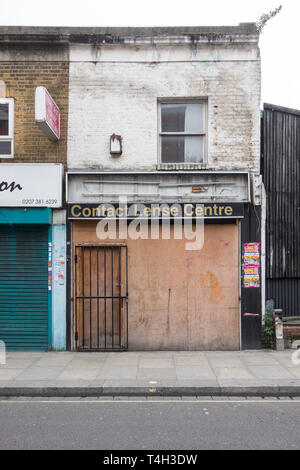 Boarded up shop front in Cradley Heath High Street with large poster ...