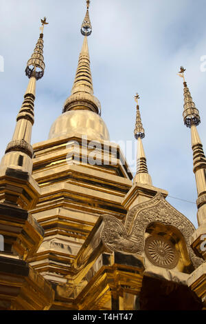 The golden spire or pagoda of Wat Phan Tao, one of the oldest temples ...