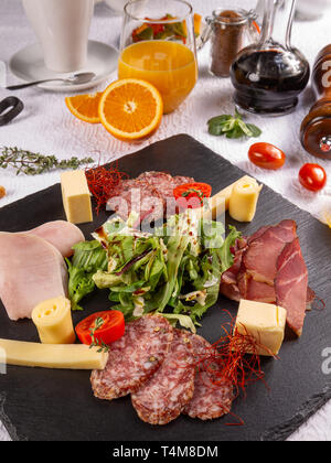 Different cold cuts for breakfast on restaurant table Stock Photo - Alamy
