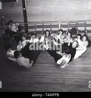 1960s, historical, ladies doing a yoga or keep fit class at the local ...