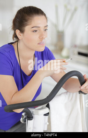 woman smoking while doing sport Stock Photo - Alamy