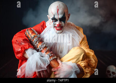 Scary bloody clown with baseball bat and air balloon, night city on ...