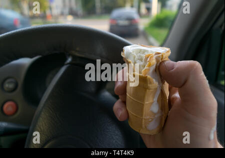 the driver holds the ice cream while driving a car Stock Photo - Alamy