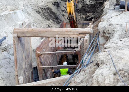 Deep trench shoring to avoid risks of landslide. Walls with supports to ...