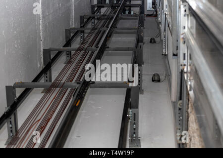 Inside elevator shaft and traction ropes. Elevator shaft maintenance ...