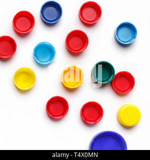 Colored plastic bottle's covers on white background, top view Stock ...
