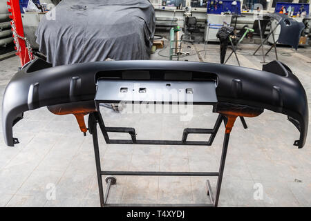 parts of a car are installed on the racks after painting in the car ...