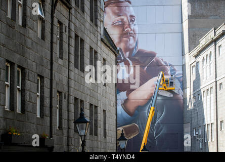 Street artist Sam Bates, aka Smug, creates a new mural for this year's ...