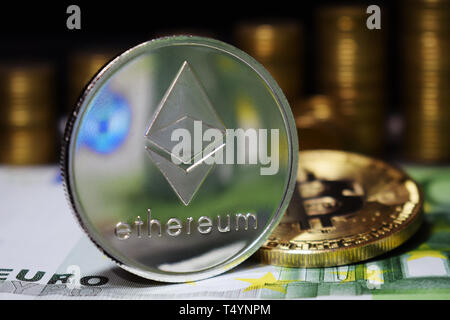 Ethereum and bitcoin coins on soft leather surface Stock Photo - Alamy