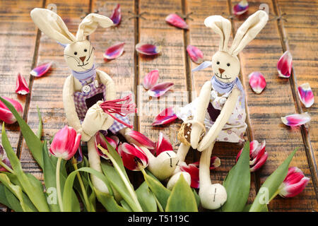 Funny handmade Easter rabbits on wooden table Stock Photo - Alamy