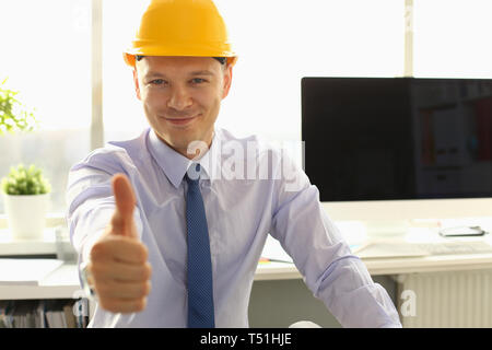 Handsome architect with helmet drawing COMPUTER TECHNOLOGY inscription ...