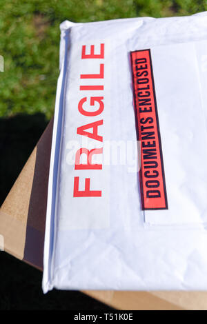 Fragile parcel against a blue sky Stock Photo - Alamy