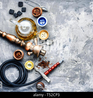 Eastern shisha or hookah for relaxation with kettle with tea.Trendy ...