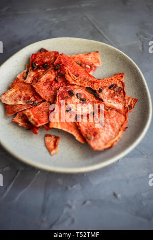 Healthy sun dried watermelon in a bowl on rustic background with copy ...