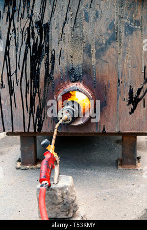 Pouring molten pitch from a tar bucket. Traditional pitch jointing for ...