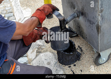 Pouring molten pitch from a tar bucket. Traditional pitch jointing for ...