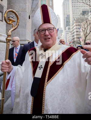 Archbishop of New York Cardinal Timothy Dolan, right, shares headgear ...
