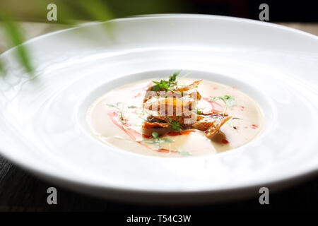 An exquisite, delicate cream soup served with crunchy crisps from baked ...