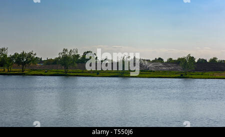 Picture of the lake at dusk and watering the field above the lake with ...