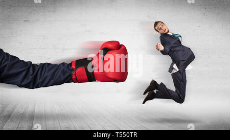 Arm with red boxing gloves hits office worker concept Stock Photo - Alamy