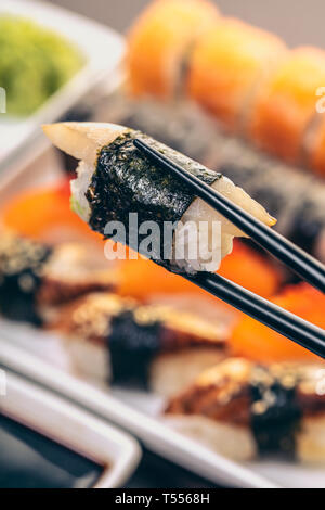 Japanese cuisine, sticks keep sushi with salmon Stock Photo - Alamy