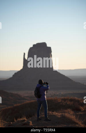 Woman photographing butte in Monument Valley, Arizona, USA Stock Photo ...