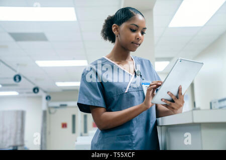 African american nurse holding digital tablet for checkup visit in ...