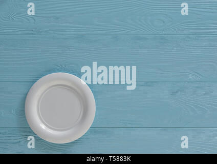 Top view of empty blue plate on wooden background. Empty space for your ...