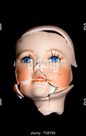 Broken Doll Body Parts Faces on Black Background Stock Photo - Alamy