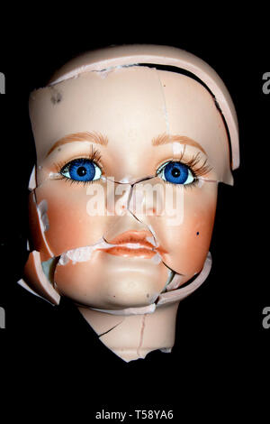 Broken Doll Body Parts Faces on Black Background Stock Photo - Alamy