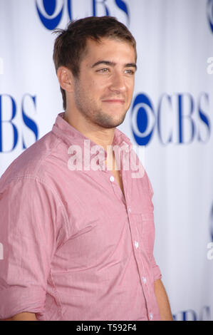 CSI Miami star Jonathan Togo leans to place a note of prayer into a ...