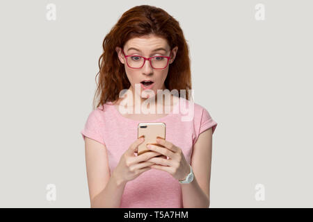 amazed redhead girl hold red heart on blue background Stock Photo - Alamy