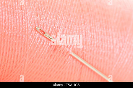 Red threat with needle, full frame, focus on needle Stock Photo - Alamy