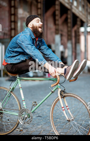 Crazy man riding bicycle on winter snowy landscape. Christmas and new year with fun Stock Photo ...