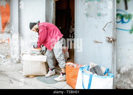 Homeless person collecting waste to recycle Stock Photo - Alamy
