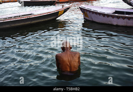 Indian Hindu man bathing and cleaning his teeth in the River Ganges by ...