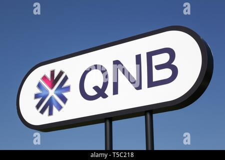 Qatar National Bank (QNB) office in Doha, with qatari flags Stock Photo ...