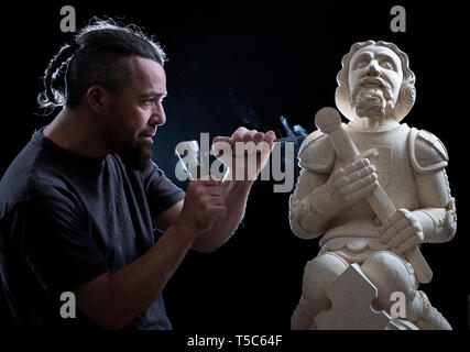 York Minster stonemason Richard Bossons adds the finishing touches to a ...