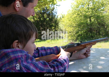 Father teaching his daughter how to shoot a hunting rifle firearm Stock ...