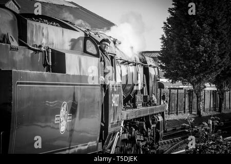 Monochrome rear view of vintage UK steam locomotive in action on Severn ...