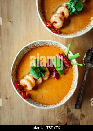 Traditional Thai tom yum soup featuring shrimp, mushrooms, and ...