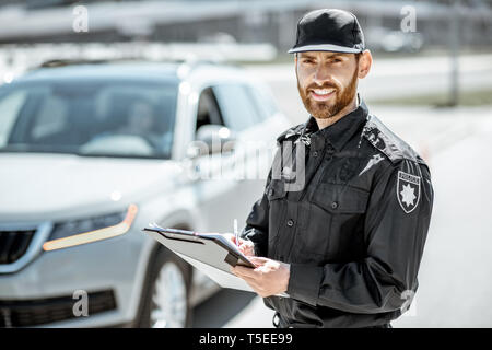 Policeman standing by car, portrait Stock Photo: 10971162 - Alamy