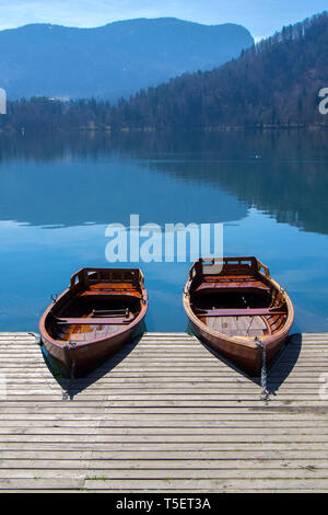 Pletna boat anchored at the pier on the lake. Pletna rowing boat and ...
