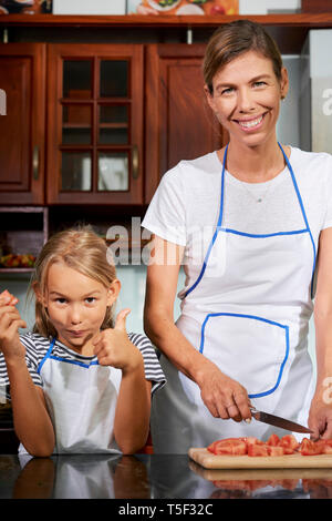 Mother and daughter cooking dinner in a kitchen Stock Photo - Alamy